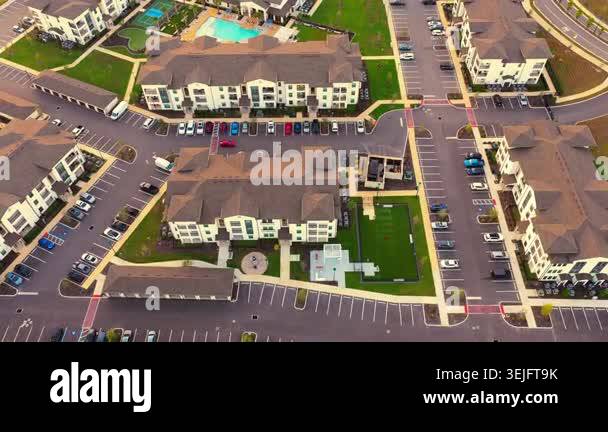 American condominium buildings in Florida suburb at sunset, reflecting ...