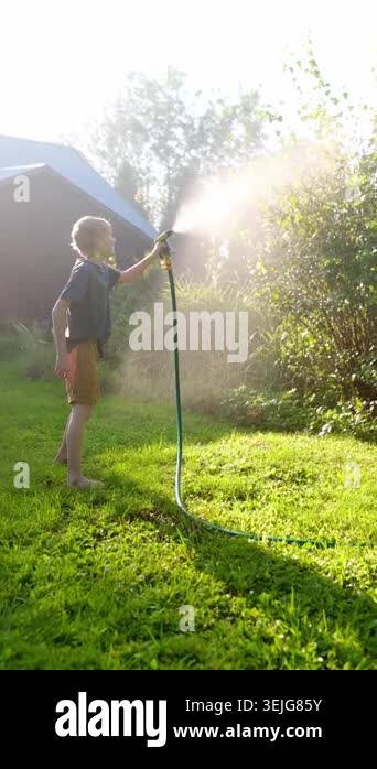 Vertical video of funny boy pouring cool water on himself and playing ...
