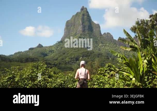 Young girl moorea volcanic mountain vista, female traveler pauses ...