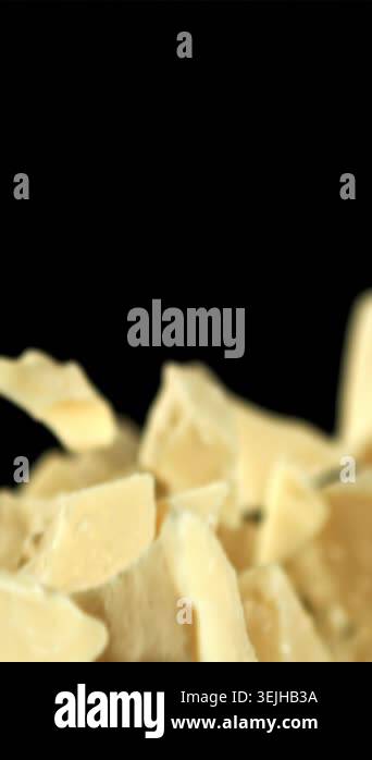Pieces of white chocolate fly up and fall down. Filmed on a high-speed ...