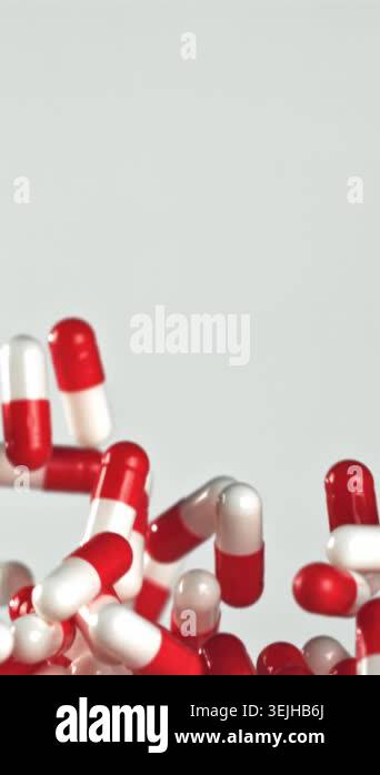 Clean grey background floating red white capsules in clinical test ...