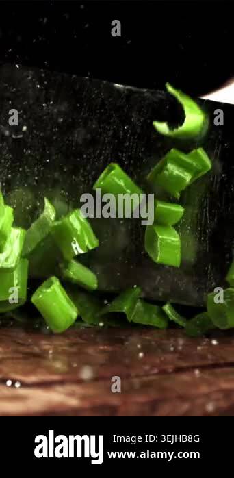 A cook chops green onions. Filmed on a high-speed camera at 1000 fps ...