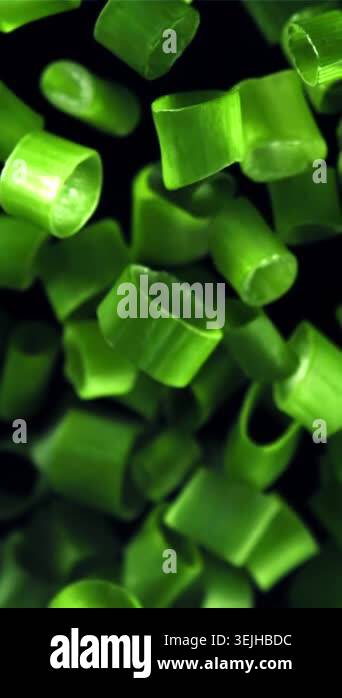 Sliced green onions fly up and fall down. Filmed on a high-speed camera ...