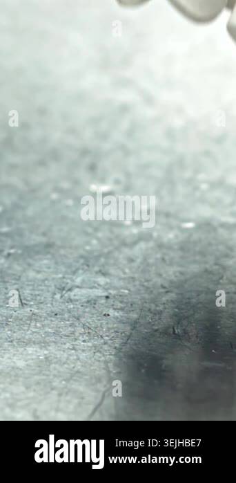 White tablets spilling across textured metal, macro view of compact ...