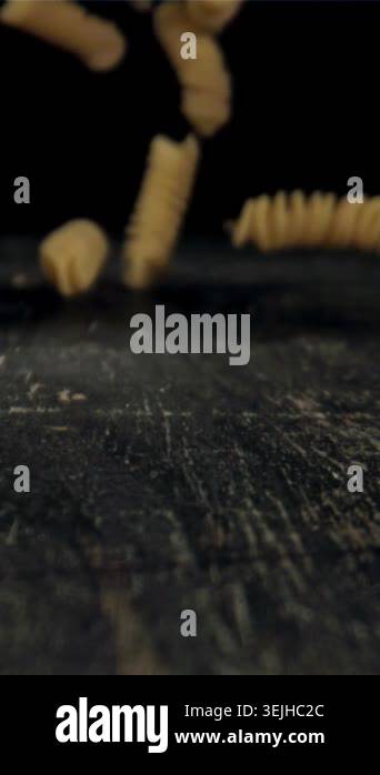 Dry pasta falls on the table. Filmed on a high-speed camera at 1000 fps ...