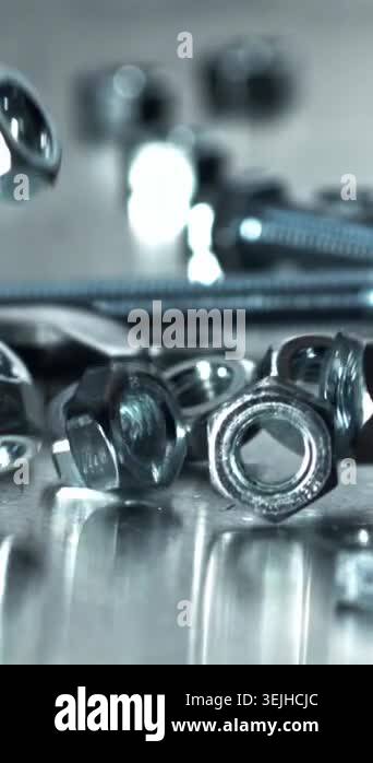 Macro view nuts bouncing across surface, reflective chrome tones ...