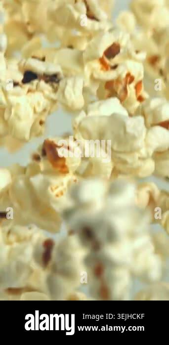 Popcorn flies up and falls down. On a light background. Filmed on a ...