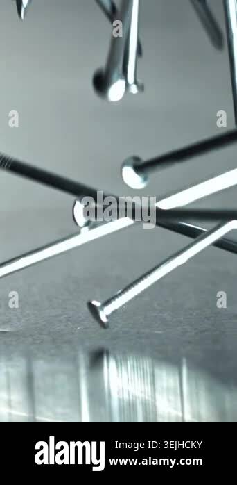 Closeup pile of scattered nails, galvanized steel sheen, carpentry ...