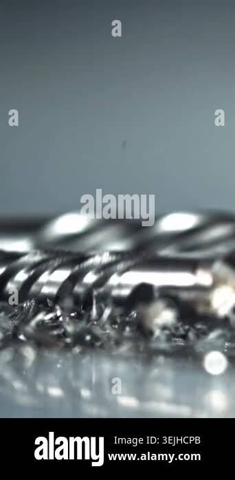 Row of drill bits on reflective plane, methodical repetition, micro ...