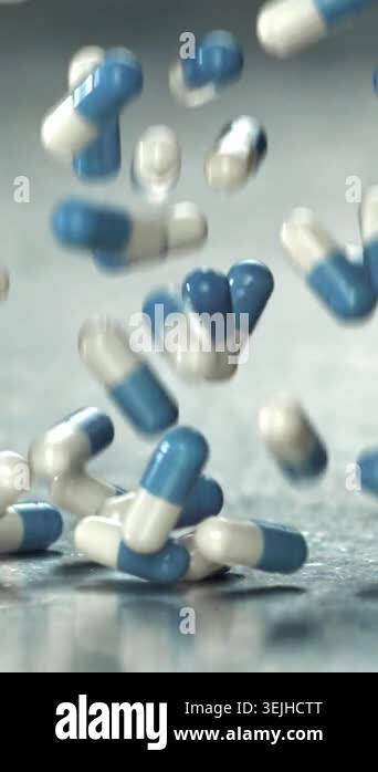 Blue and white capsules cascading on metallic surface, sterile Filmed ...