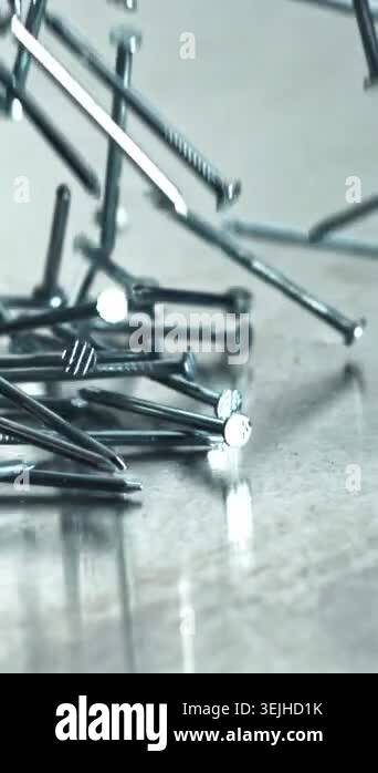 Scattered nails bouncing across steel floor, kinetic motion with crisp ...