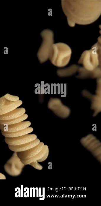 Fusili pasta falls down. Filmed on a high-speed camera at 1000 fps ...