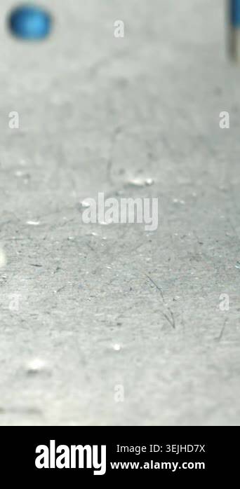 Blue and white capsules scattered on brushed metal, clinical calm tone ...