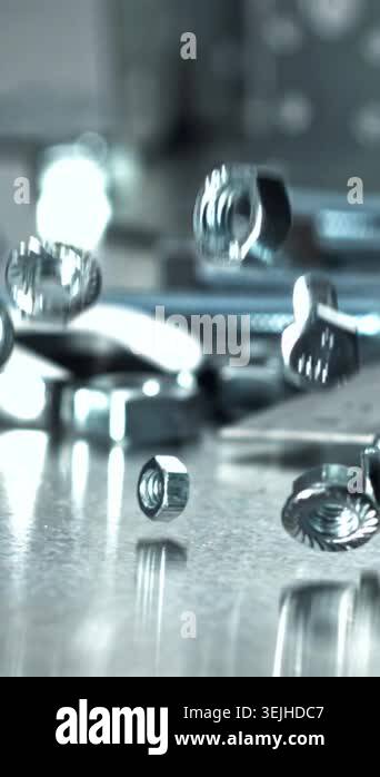 Closeup assorted screws nuts and washers scattering on reflective ...