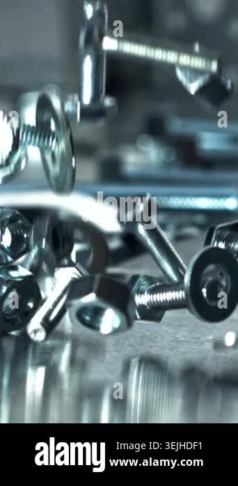Shiny steel bolts scattered on reflective workbench, cinematic macro ...