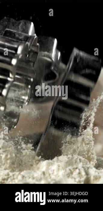 Cookie cutters fall into the flour. Filmed on a high-speed camera at ...