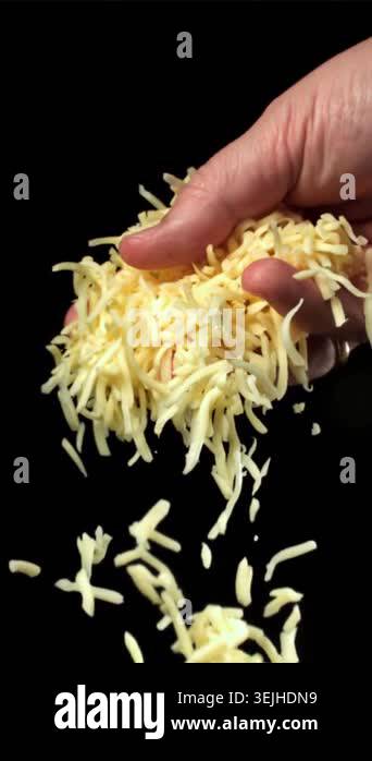 Grated cheese falls out of the cooks hand. Filmed on a high-speed ...