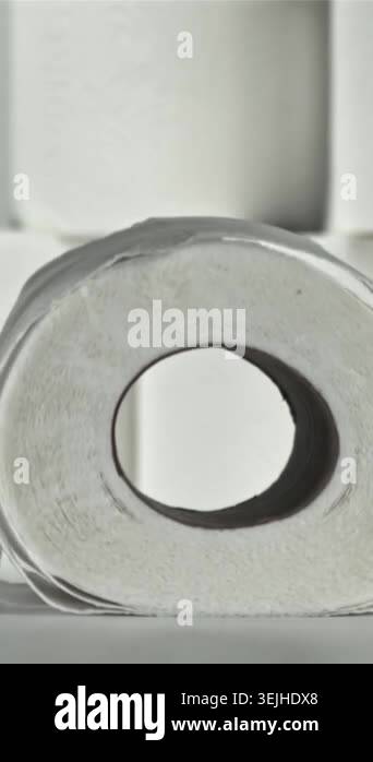 Toilet paper falling on the table on a white background. Filmed on a ...