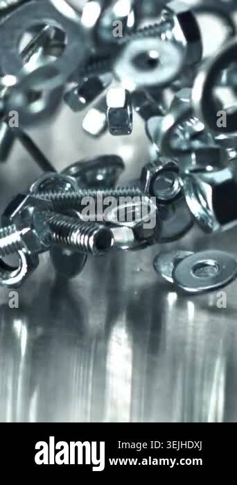 Macro view scattered nuts washers bolts, chrome finish, shallow focus ...