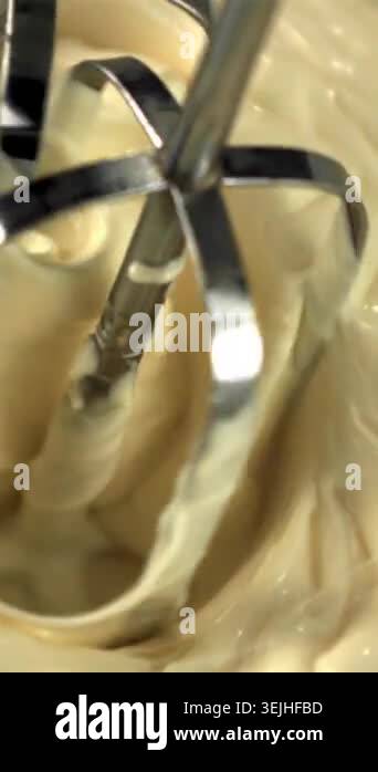 Super slow motion whipping homemade mayonnaise with a mixer. Macro ...