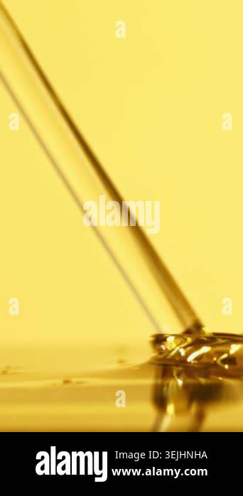 Olive oil pours in a stream with splashes. Macro background. Filmed on ...