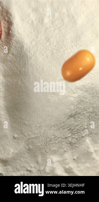 Super slow motion egg falls into a pile of flour on the table. Macro ...