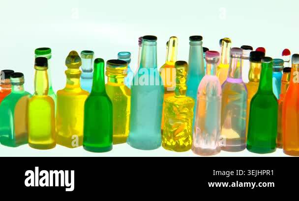 various miniature resin bottles of alcohol without labels in motion on ...