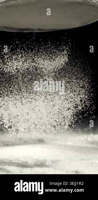 Super slow motion for baking flour is sifted through a sieve. On a ...