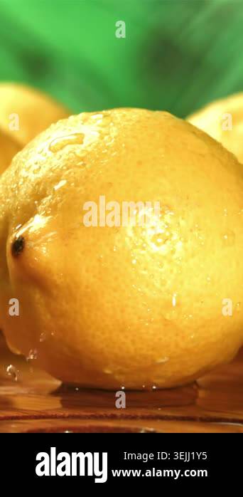 A knife cuts a lemon on a cutting board. Filmed on a high-speed camera ...