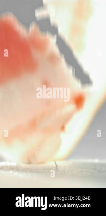 Bacon falling on white background. Filmed on a high-speed camera at ...