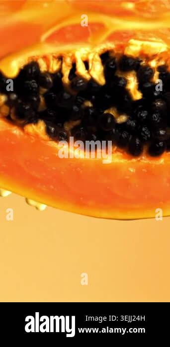 Fresh papaya with a splash of juice. Filmed on a high-speed camera at ...