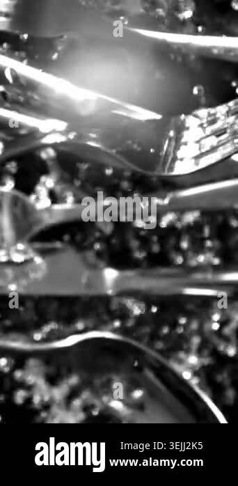 Cutlery flies up with splashes of water. View from above. Filmed on a ...