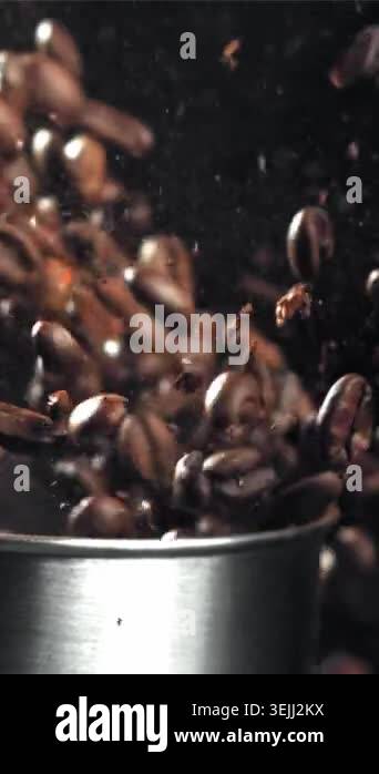 The coffee beans fall into the working grinder. Filmed on a high-speed ...