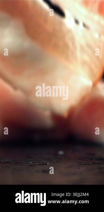 Fresh bacon falling on black background. Filmed on a high-speed camera ...