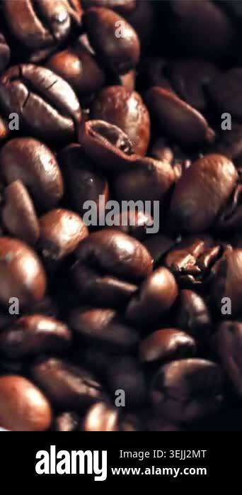 Coffee beans in a working grinder. Filmed on a high-speed camera at ...