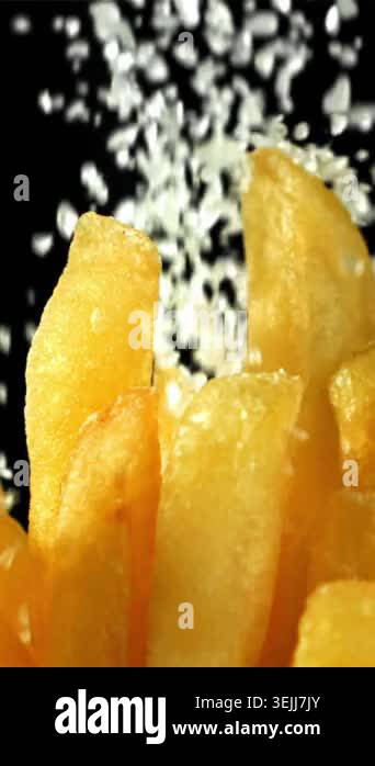 Salt falls on the french fries. Filmed on a high-speed camera at 1000 ...