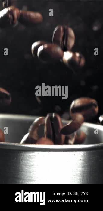 The coffee beans fall into the working grinder. Filmed on a high-speed ...