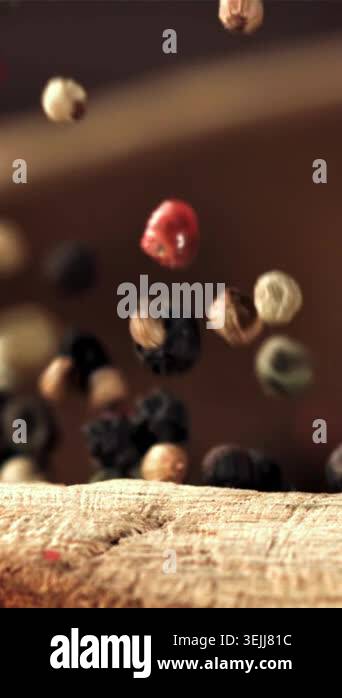 Peppercorn falling into a wooden plate. Filmed on a high-speed camera ...