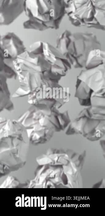 Crumpled paper flies up and falls on a white background. Filmed on a ...