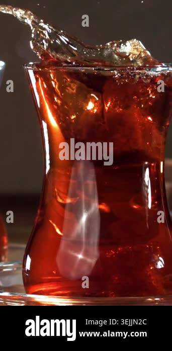 A sugar cube falls into Turkish tea. Filmed on a high-speed camera at ...
