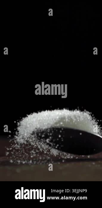 A spoonful of sugar falls on the table. Filmed on a high-speed camera ...