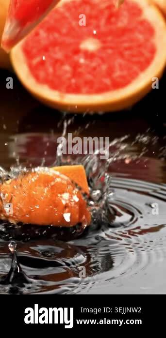 Super slow motion pieces of fresh grapefruit . Filmed on a high-speed ...