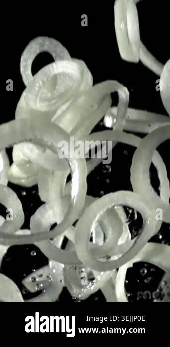 Rings of chopped onions fly up and down. Filmed on a high-speed camera ...