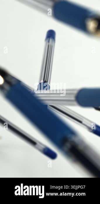 School pens fly up and down. Filmed on a high-speed camera at 1000 fps ...
