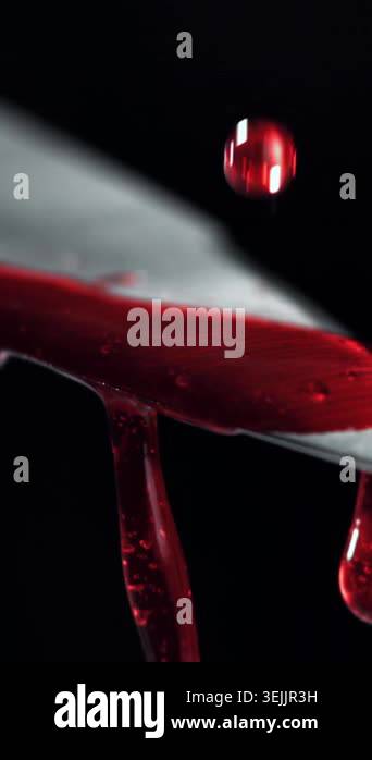 Blood dripping from the knife blade. Filmed on a high-speed camera at ...