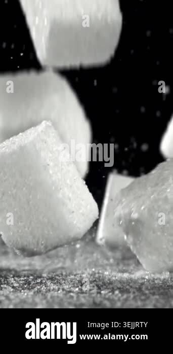 Sugar cubes fall on the table. Filmed on a high-speed camera at 1000 ...