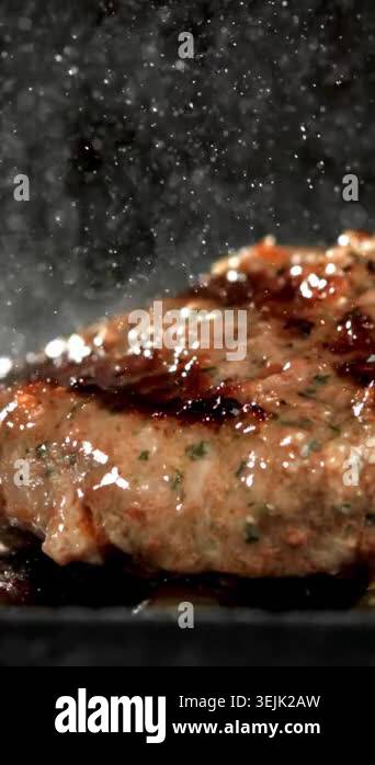 Beef burger is fried in a grill pan. Filmed on a high-speed camera at ...