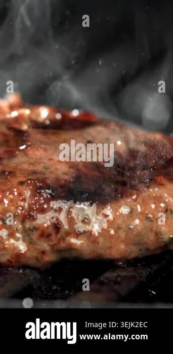 Beef burger is fried in a grill pan. Filmed on a high-speed camera at ...