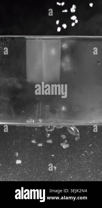 The cook salts the water in a saucepan. Filmed on a high-speed camera ...