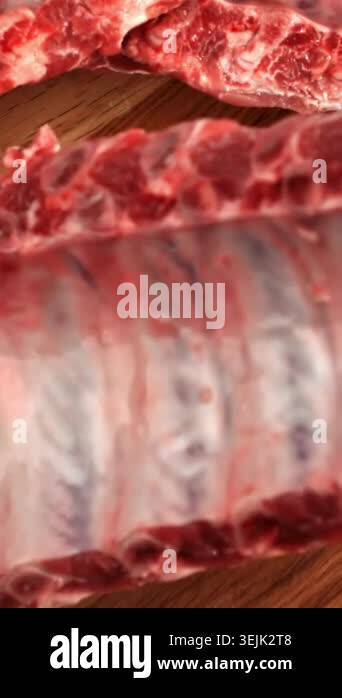 Raw pork ribs fall onto a cutting board. Filmed on a high-speed camera ...